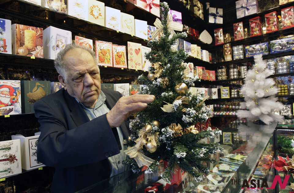 A Muslim Iranian Decorates Christmas Tree At His Shop In Christian ...