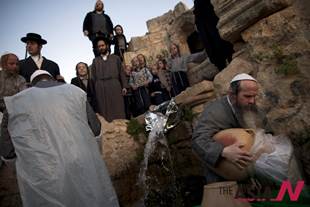 Jews collect water at a mountain spring to prepare for celebration of ...